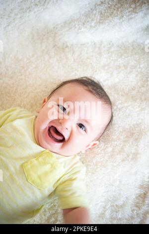 Laughing baby on back Stock Photo - Alamy