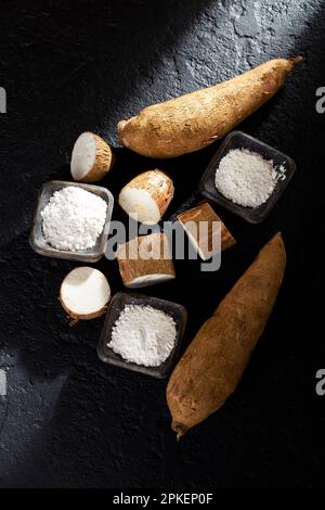 pile of cassava, cassava and cassava flour on a background of rustic ...