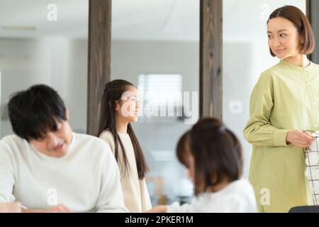 Parents and children doing housework and painting Stock Photo - Alamy