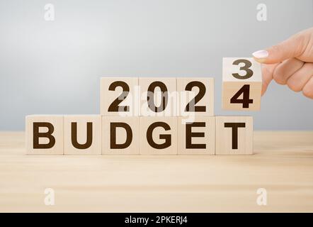 Planning 2024 changes new year symbol. Businessman turns a wooden cube with words Changes 2023 ...