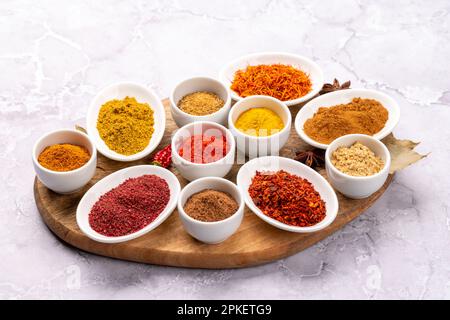 Various dried spices in small bowls on stone table Stock Photo - Alamy