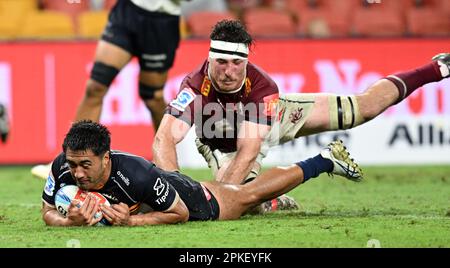 Tamati Tua (left) of the Brumbies dives over to score a try during the ...
