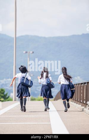 Junior high school students running side by side Stock Photo - Alamy