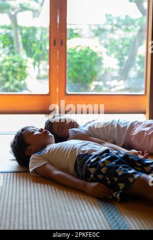 Sister and brother taking a nap in a Japanese-style room Stock Photo ...