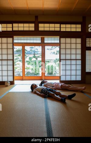 Sister and brother taking a nap in a Japanese-style room Stock Photo ...