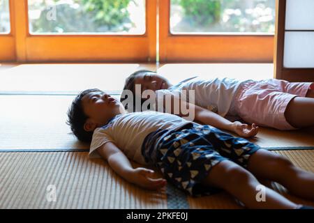 Sister and brother taking a nap in a Japanese-style room Stock Photo ...