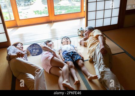 Grandparents and grandchildren taking a nap in Japanese-style room ...