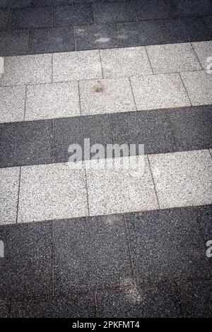 Textured walkway for blind people. Black tactile paving for the ...