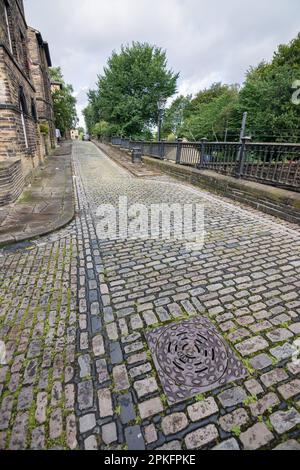 Victorian cobbled street alongside Saltaire Railway Station, Saltaire ...