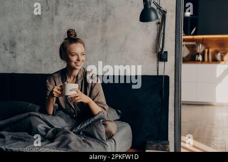 Starting his work day with a smile. Smiling young businessman enjoying ...