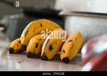 a bunch of bananas in a brown paper bag top view. Buying bananas at the ...