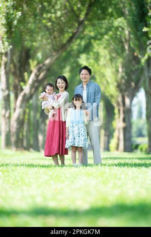 Family smiling at a row of poplar trees Stock Photo - Alamy