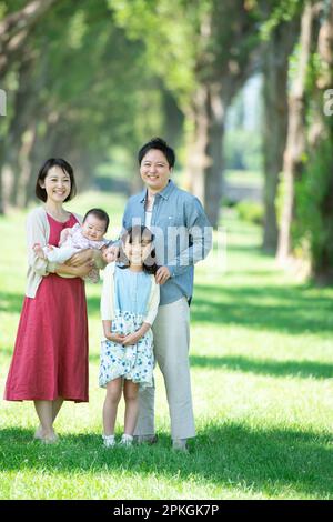 Family smiling at poplar trees Stock Photo - Alamy