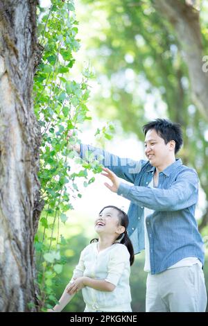 Parent and child observing a plant Stock Photo - Alamy
