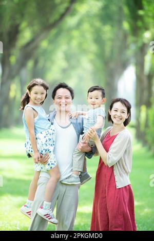 Family smiling at poplar trees Stock Photo - Alamy