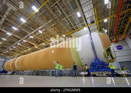 Technicians at NASA’s Michoud Assembly Facility move the engine section ...
