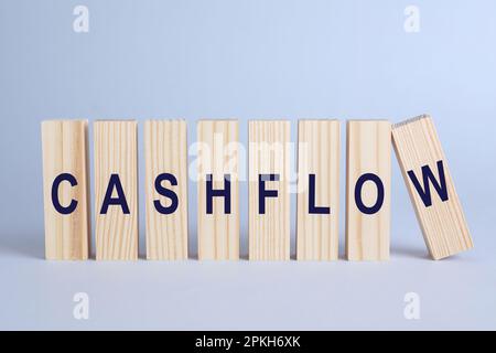 Wooden blocks with phrase Cash FLow on grey background, above view ...