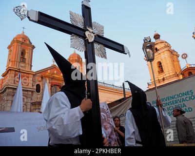 Catholic devotees carrying on a religious procession at eve on Holy ...