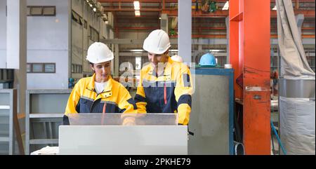 Two hispanic labor dressed in hardhat and polyester jacket uniform ...