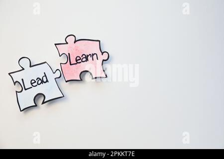 Paper puzzle pieces with words Lead and Learn on white background, flat ...
