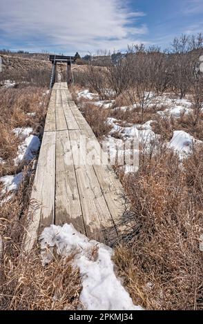 Pedestrian bridge over the Rosebud River at the ghost town of Beynon in ...