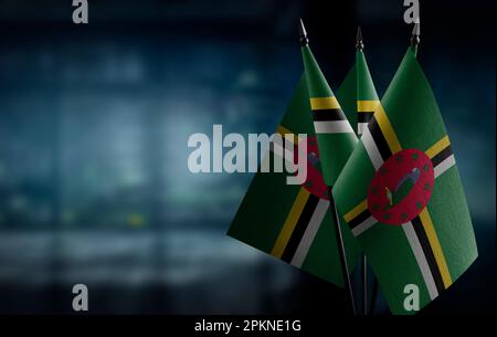 Small flags of the Dominica on an abstract blurry background Stock ...