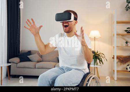 Disabled man with virtual glasses Stock Photo - Alamy