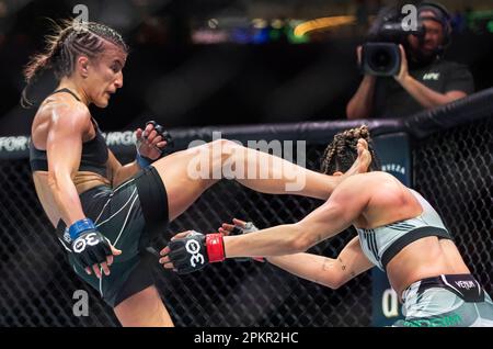 Sam Hughes, left, and Jaqueline Amorim fight during their straw weight ...