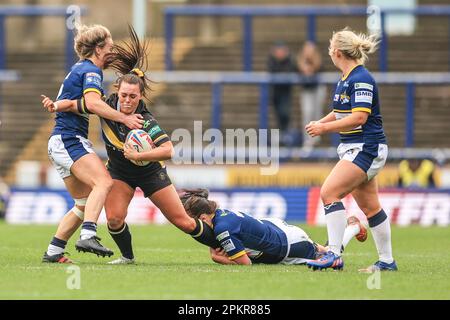 Lacey Owen of York Valkyrie is tackled by Izzy Northrop of Leeds Rhinos ...