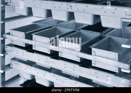 Rack with metal containers for cooking food Stock Photo - Alamy