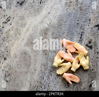 Plastic toy finger hands in different skin tones; help, assistance ...