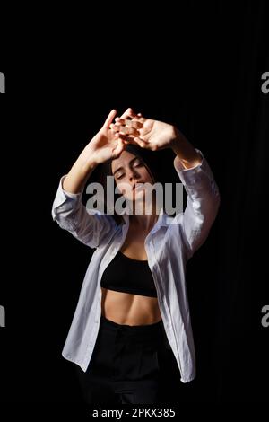 brunette actress dances barefoot in the rehearsal hall of the theater ...