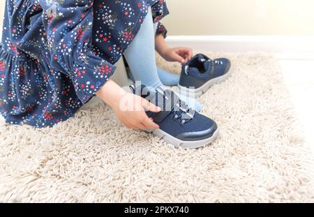 Little girl taking off her shoes Stock Photo - Alamy