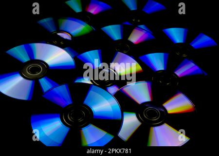 CD and DVD isolated on black background with colorful light reflections ...