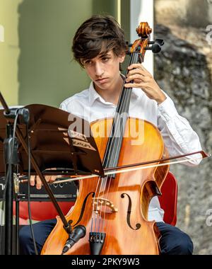 Outdoor classical recital by string trio Stock Photo - Alamy