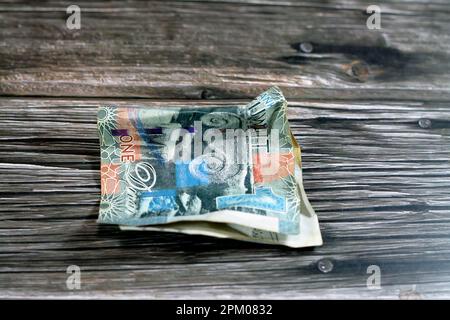 Wrinkled and crumpled Kuwaiti 1 KWD one dinar bill banknote and 1 one ...