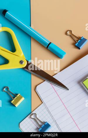 Colorful pencils, paints, school supplies and plasticine on green grass ...