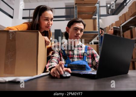 Warehouse managers preparing customer order and checking pick ticket on ...