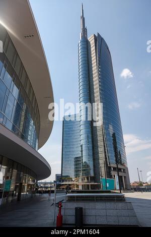 A sleek industrial skyscraper dominates the urban landscape as a city ...