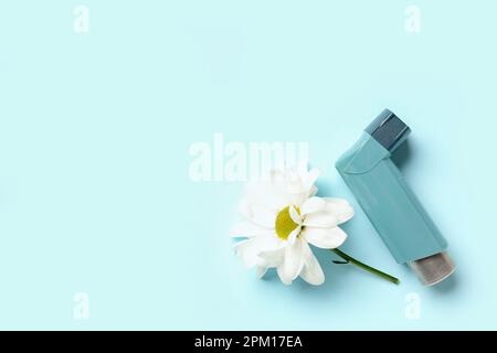 Asthma inhaler with daisy flower on color background Stock Photo - Alamy