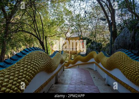 Steps up to a limestone hill decorated with dragons at Wat Phra ...