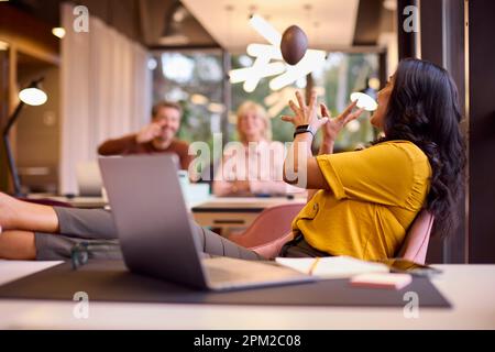 Woman businesswoman with american football Stock Photo - Alamy