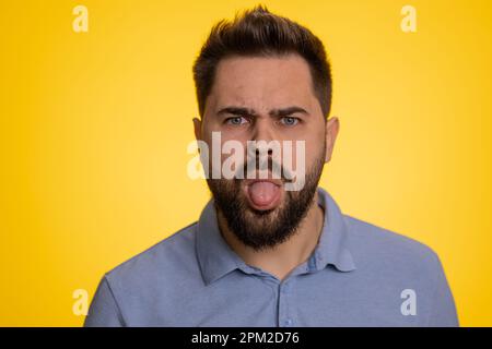 Childish disobedient behavior. Portrait of attractive teenager guy ...
