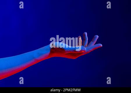 Exposed hand in studio with blue light with copy space Stock Photo - Alamy