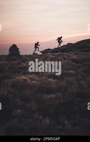 Silhouette male trail runners running over ridge at dawn sunrise Stock ...