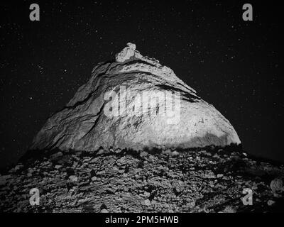 Illuminated rock formation at the Trona Pinnacles at night with stars ...