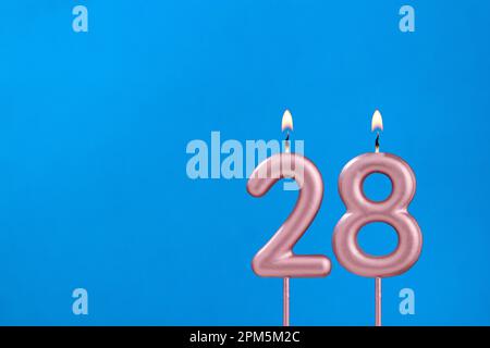 Candle number 8 - Birthday in blues foamy background Stock Photo - Alamy