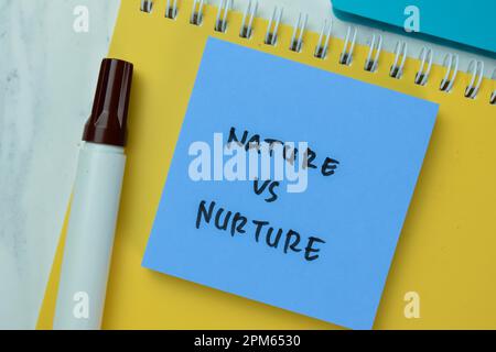 Concept of Nature vs Nurture write on sticky notes isolated on Wooden ...