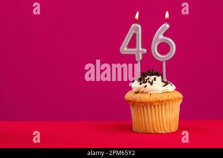 Candle number 46 - Cake birthday in blue background Stock Photo - Alamy