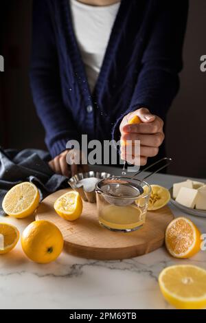 Squeezing Lemons for Lemon Curd Stock Photo - Alamy